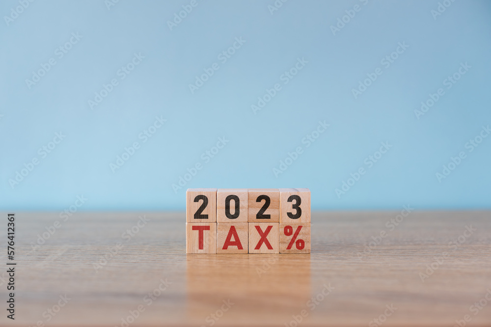 Tax and 2023 number on wooden block. Pay tax in 2023 years. The new ...