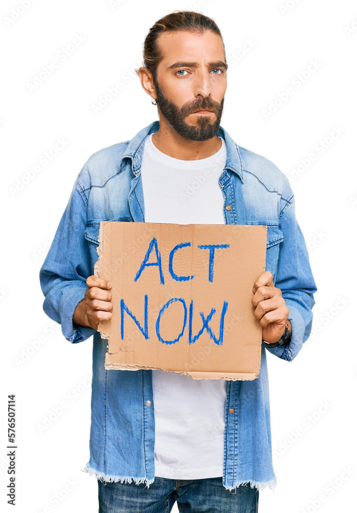 Attractive man with long hair and beard holding act now banner thinking ...