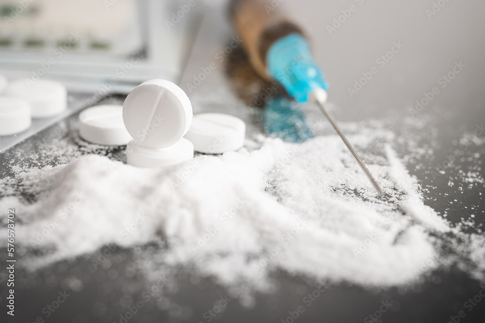 White pills, drugs or medical treatment, cocaine or heroin white powder ...