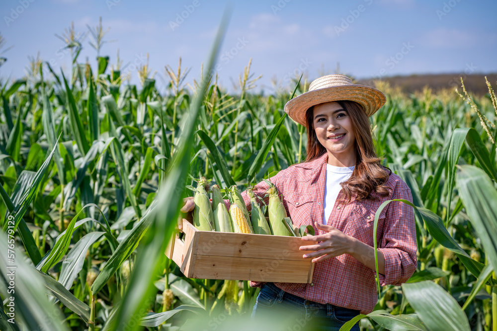 Happy asian woman farmer wearing a red shirt,hat and white gloves.she ...