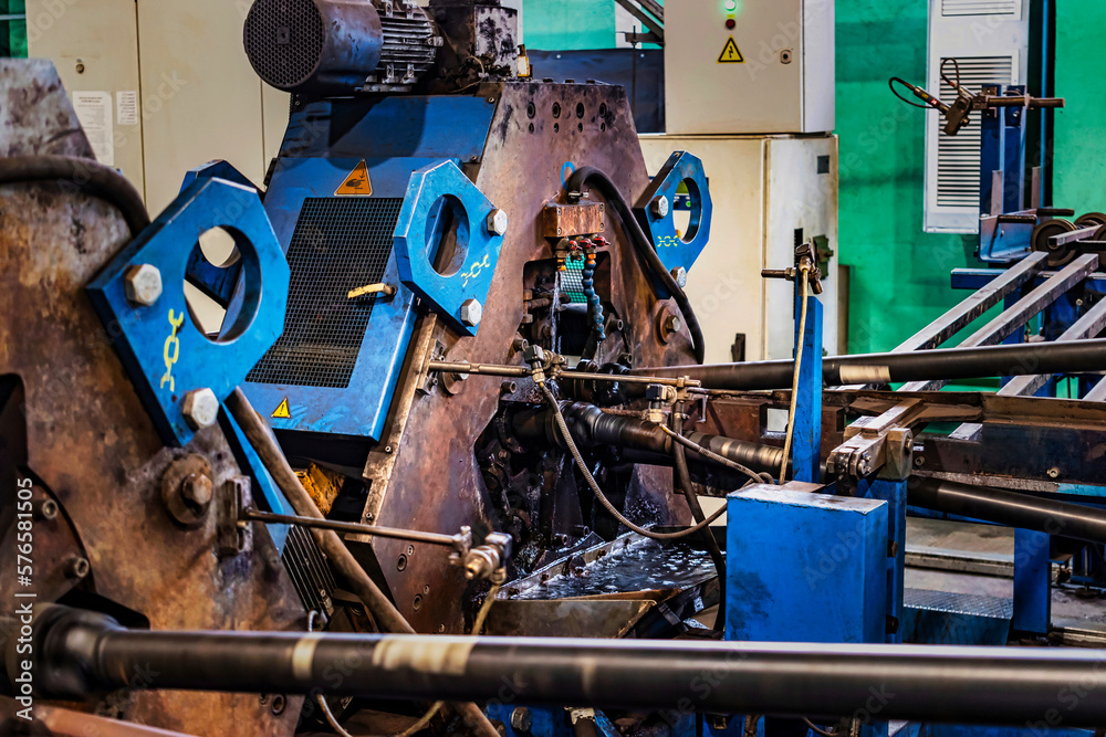 Machine for induction heating of metal. A metal rod heated in an ...