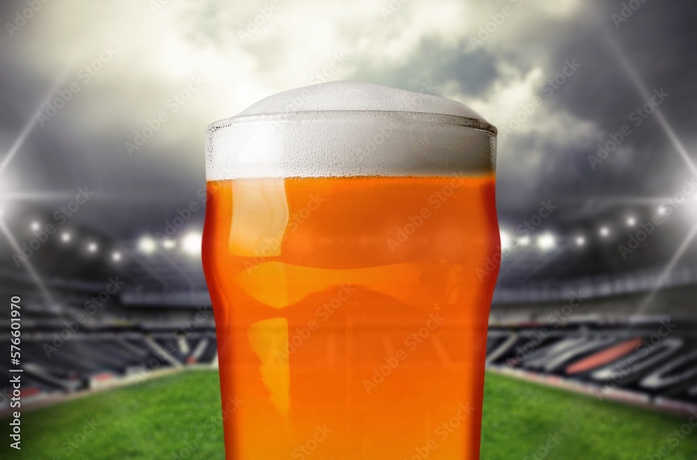 Foamy chill beer on football stadium background Stock Photo | Adobe Stock