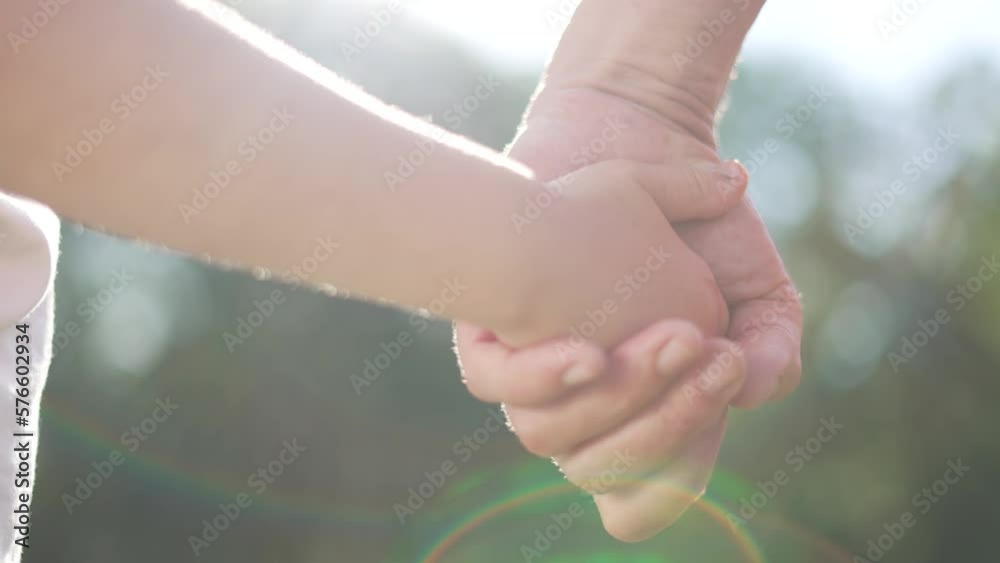 happy family father and daughter hold hands close up. Dad and baby girl ...
