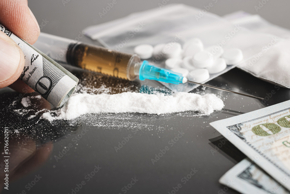Snorting cocaine, white powder line, rolled up dollar bill, white pills ...