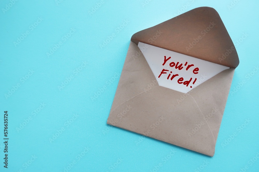 On blue copy space background, office envelope with handwritten card ...