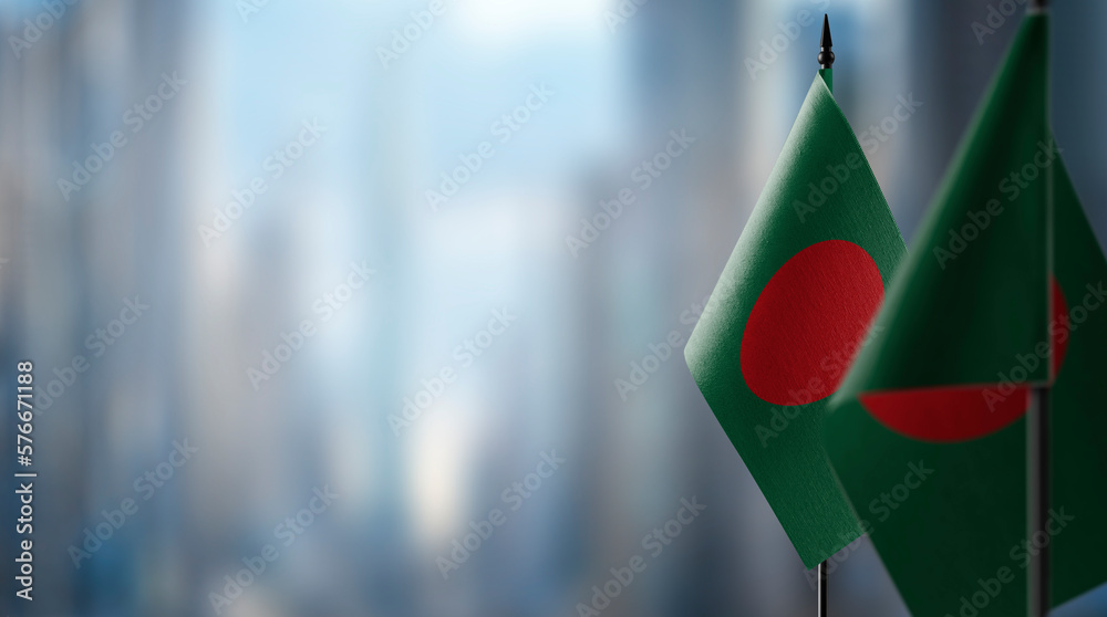 Small flags of the Bangladesh on an abstract blurry background foto de ...
