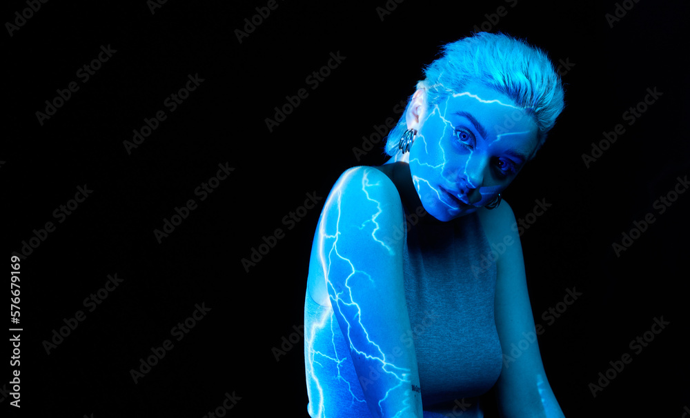 Lightening. Portrait of young blonde girl with abstract neon stripes on ...