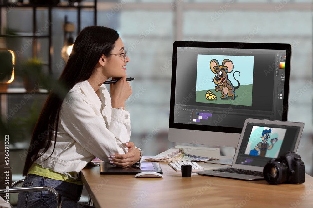 Animator working with computer and laptop. Illustrations on screens ...