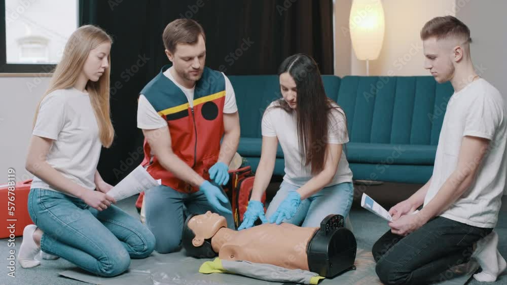 CPR training using and an AED and bag mask valve on an adult training ...