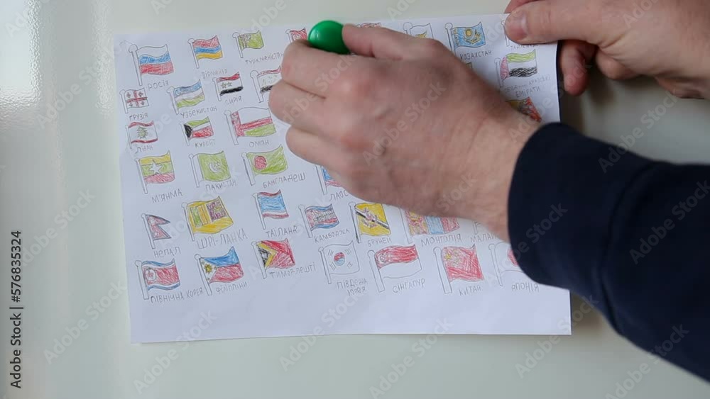 The child drew the flags of different countries with colored pencils ...
