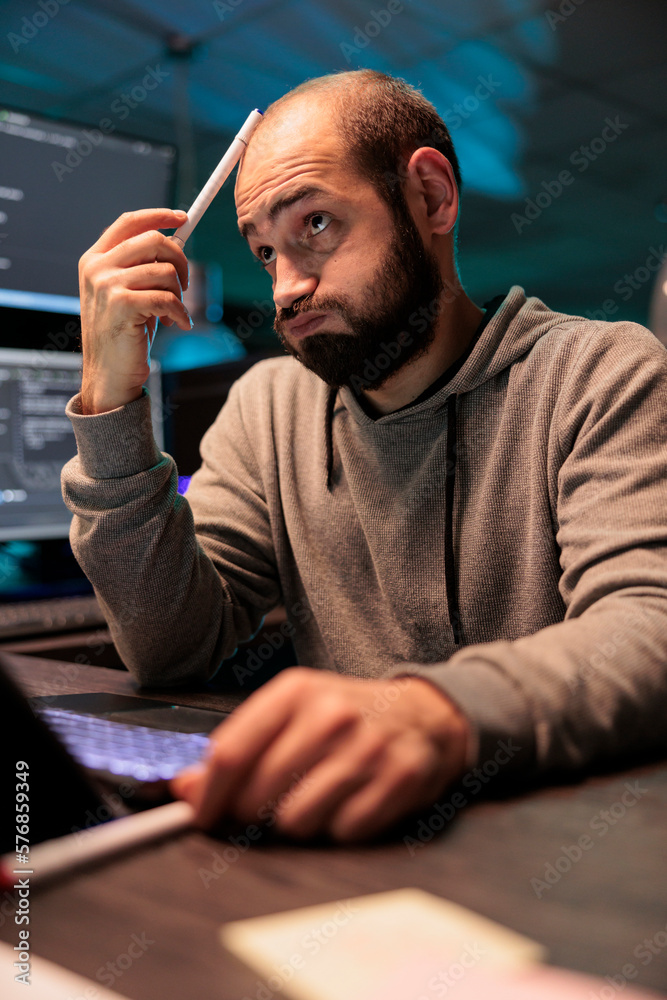 Thoughtful developer brainstorming ideas to find source code and develop html script on terminal ...