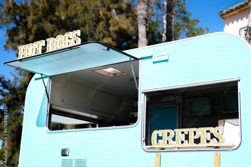 Blue and white caravan transformed into food truck with hot dog and ...