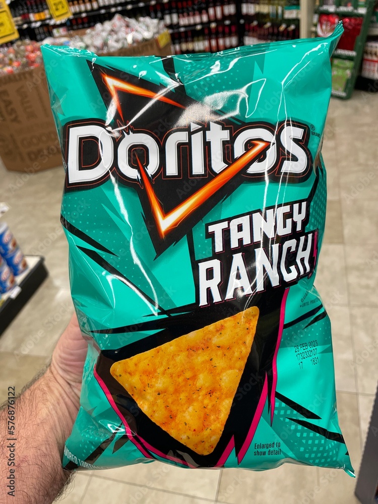 Grocery store hand holding Doritos tangy ranch chips in a bag Stock ...