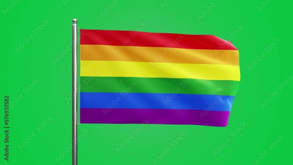 A LGBTQ+ rainbow progress pride flag flaps from a flagpole in a brisk ...