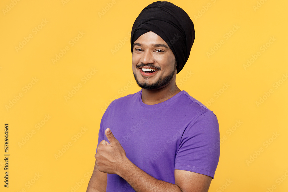 Side view smiling devotee Sikh Indian man tie his traditional turban ...