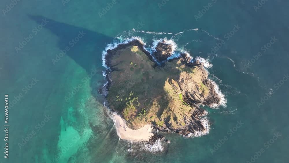 overhead aerial drone footage of mokulua island at sunrise with clear ...
