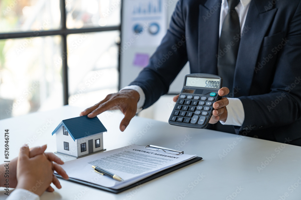 Young Asian businessman or insurance salesman explaining details of ...