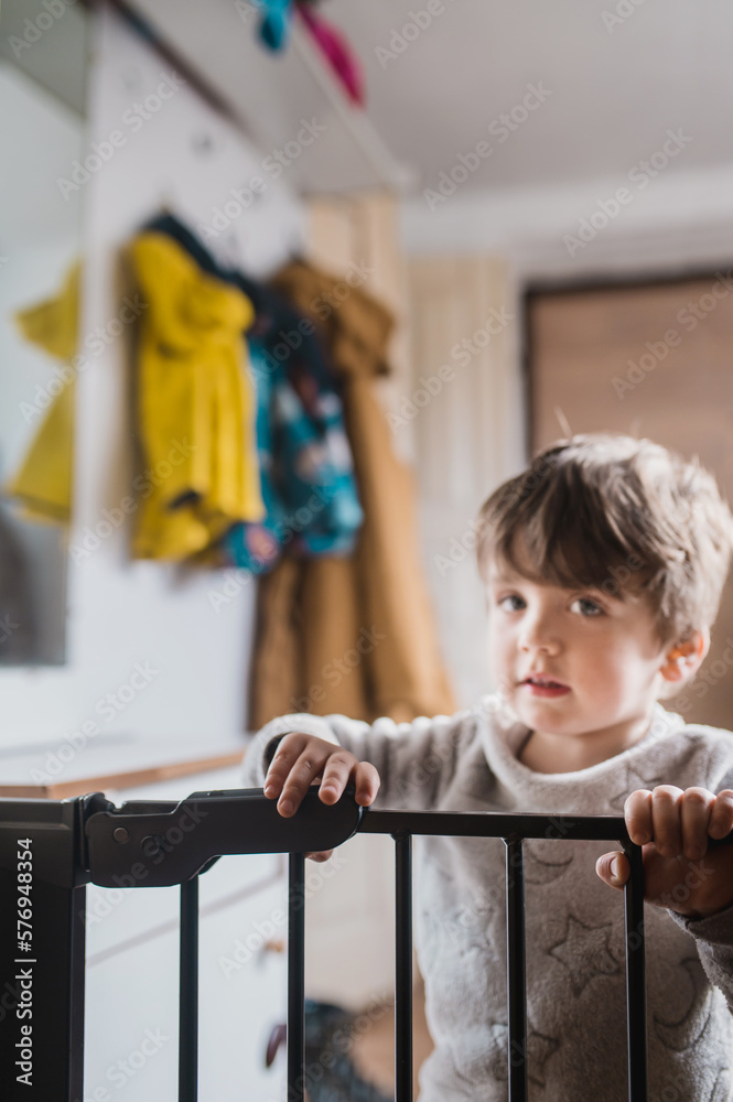 Front view of a little boy standing on the other side of the child ...