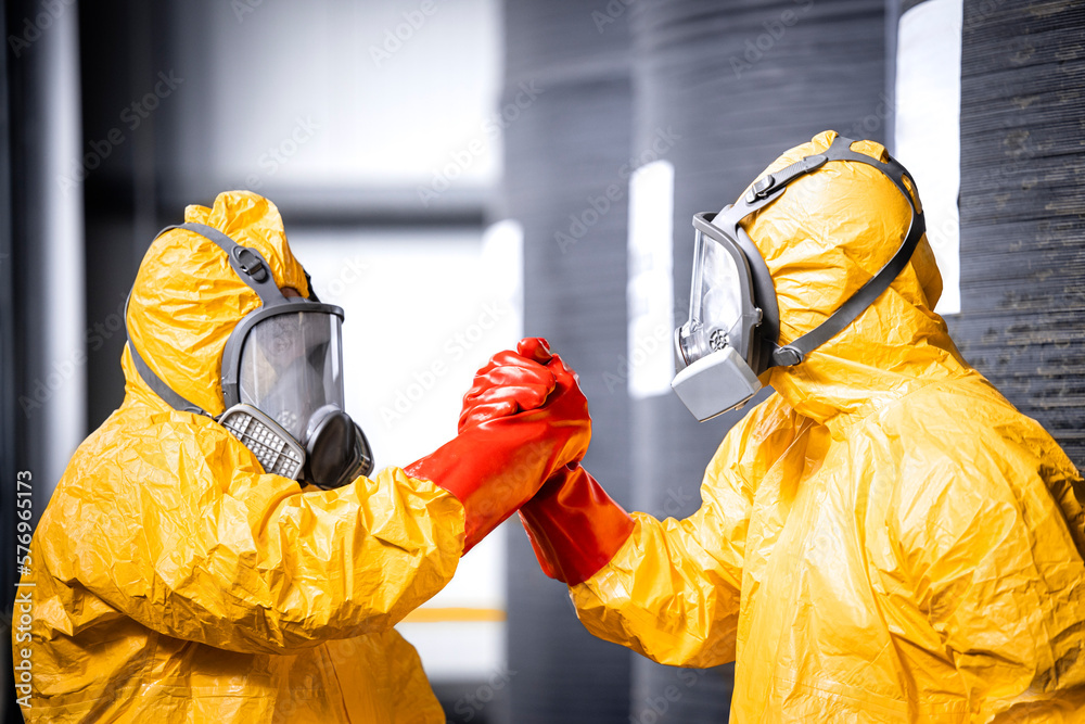 Chemicals workers in protection suit, gas mask and gloves celebrating ...