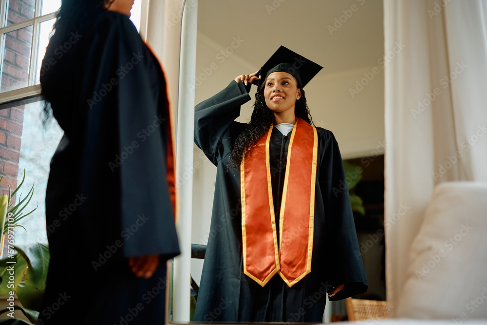Reflection in mirror of female African American student in graduation ...