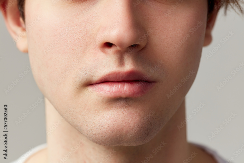 Cropped image of male face nose, lips, chin. Young model posing over ...