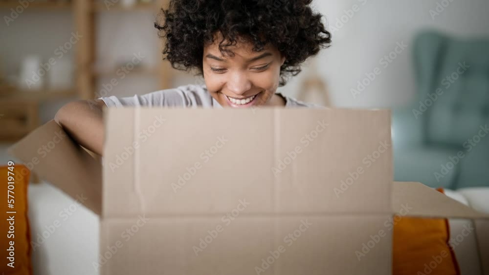 Happy satisfied african american woman customer receive carton box and ...