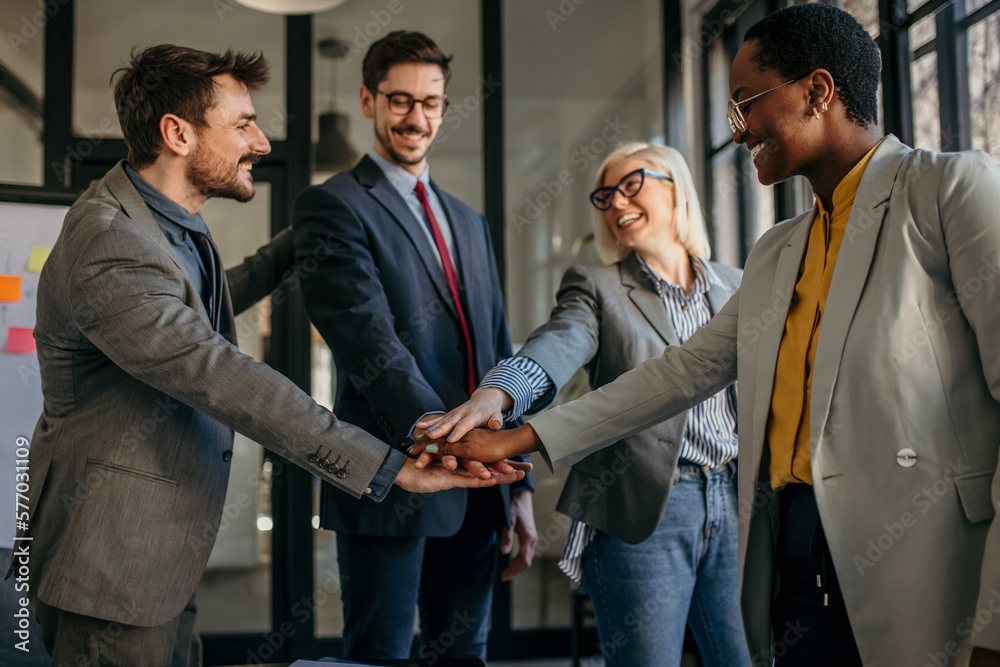 Happy diverse colleagues team people give hands on hands. Business ...