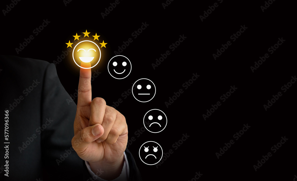 Businessman pressed the smile face emoticon on the virtual touch screen ...