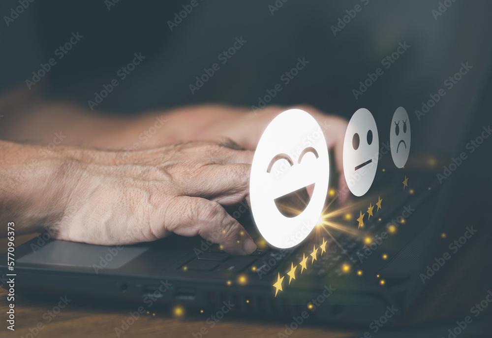 Businessman pressed the smile face emoticon on the virtual touch screen ...