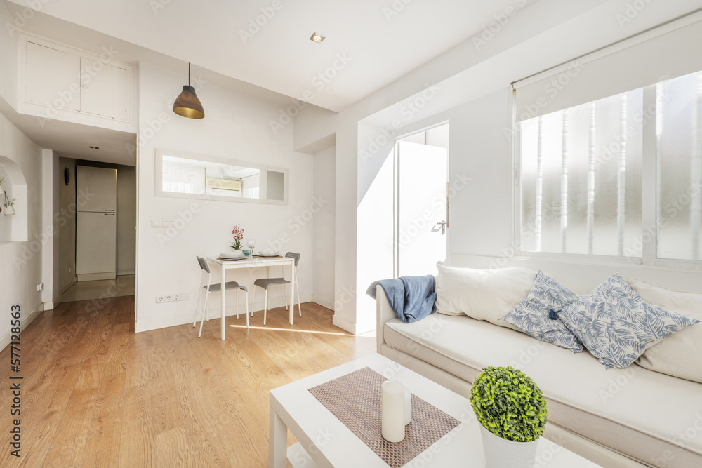 Living room of a loft-style rental house with a white three-seater sofa ...