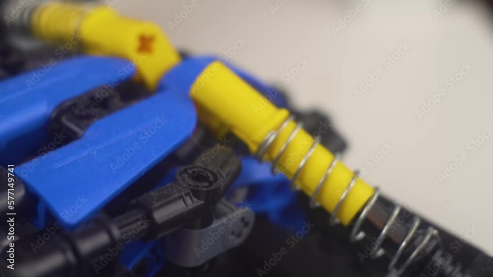 Macro demonstration of suspension strength on chassis of toy car ...