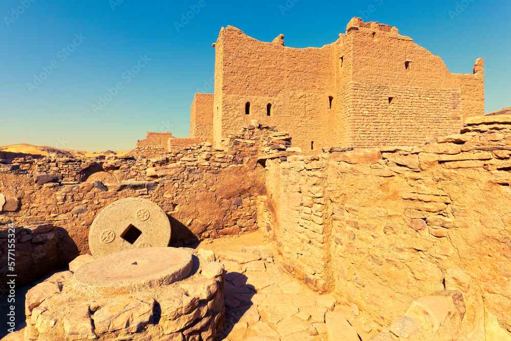 Millstone with Coptic crosses in half ruined Monastery of St. Simeon in ...