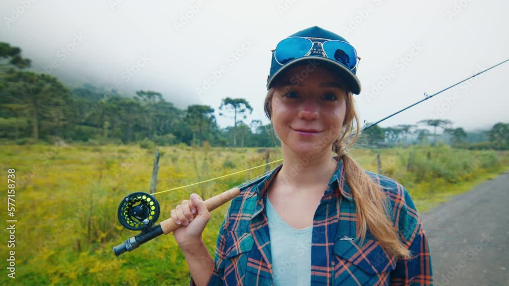 Fisherwoman in the rural area. Portrait of the pretty woman angler ...