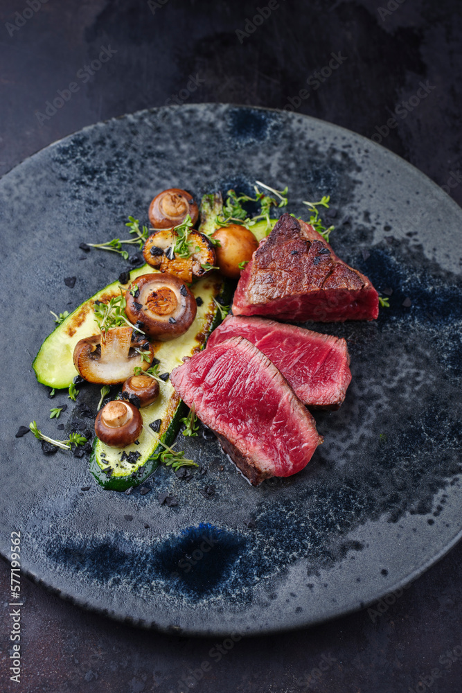 Fried Italian chianina beef fillet steak very rare with mushrooms and ...