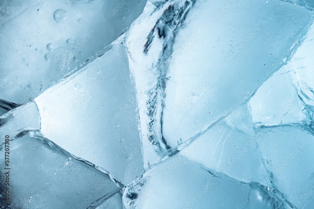 Abstract ice background. Blue background with cracks on the ice surface ...