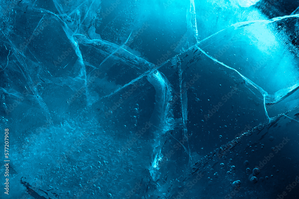 Abstract ice background. Blue background with cracks on the ice surface ...