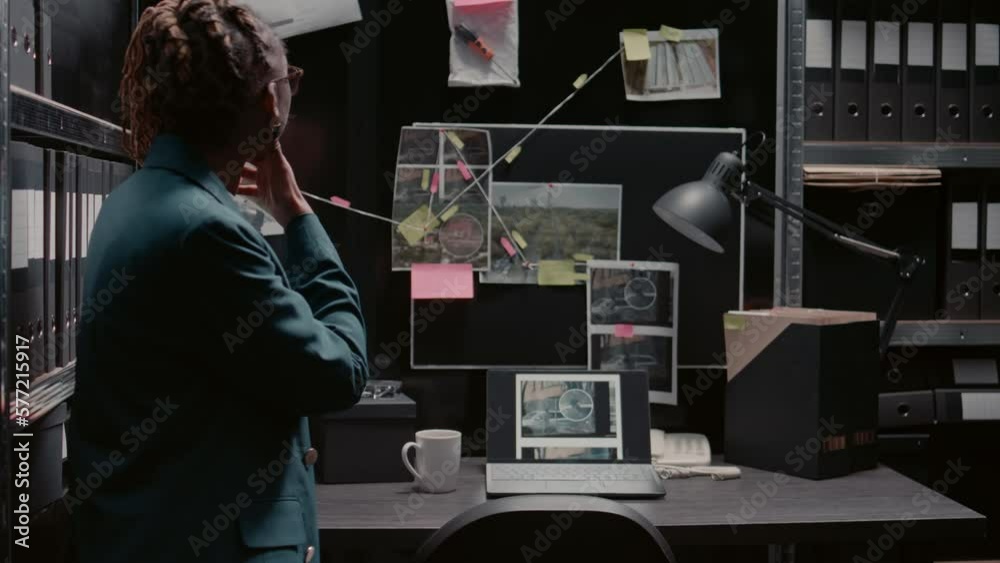 Professional officer reviewing surveillance photos on files to solve ...