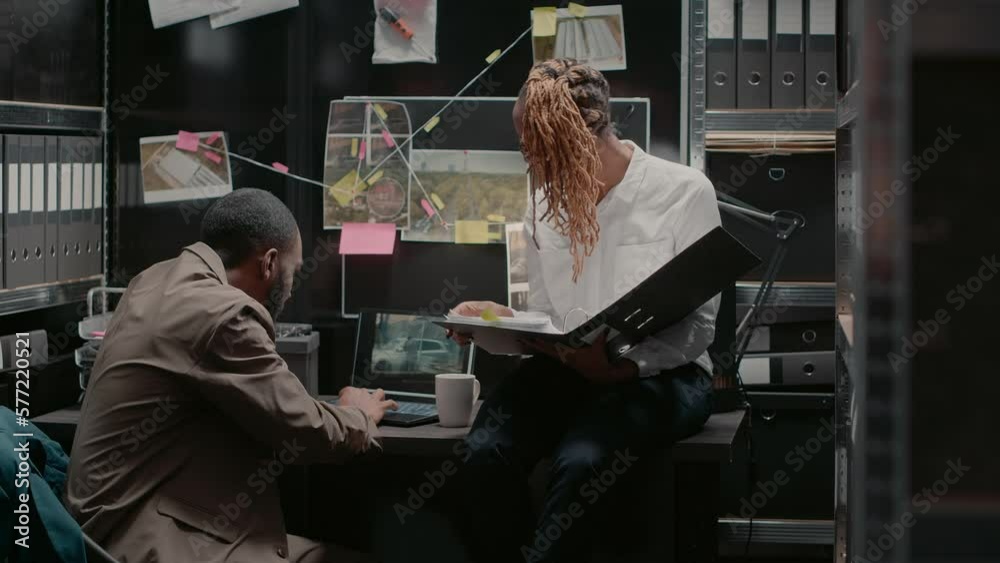 Two police officers looking at detective evidence map, investigators ...