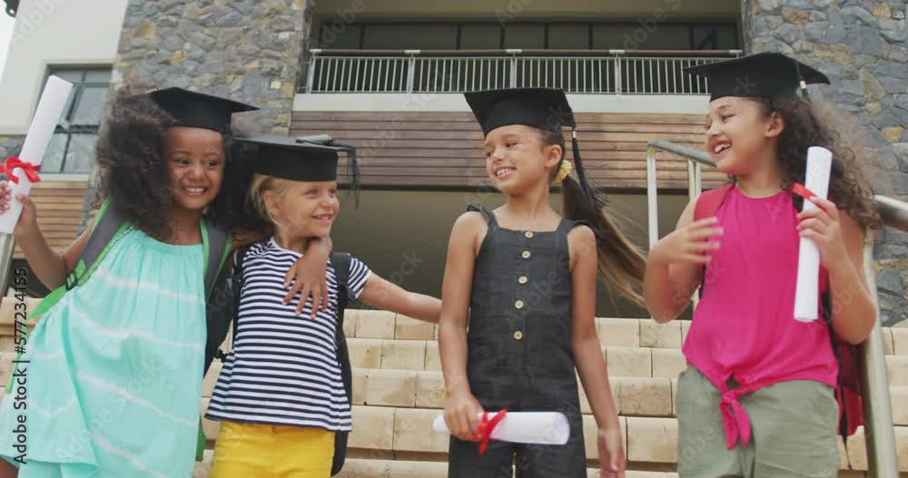 Video of happy diverse girls wearing graduation hats and holding ...