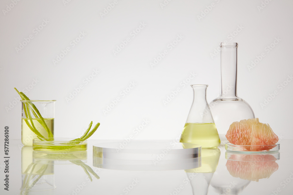 Pink pomelo peels and slices decorated with few laboratory glassware ...