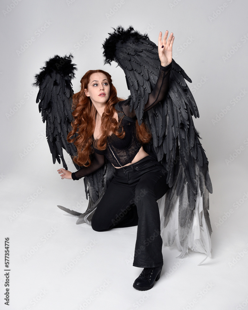 Full length portrait of beautiful woman with long red hair wearing ...