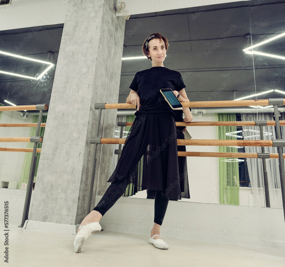ballet teacher in the choreography class stands at the ballet machine ...