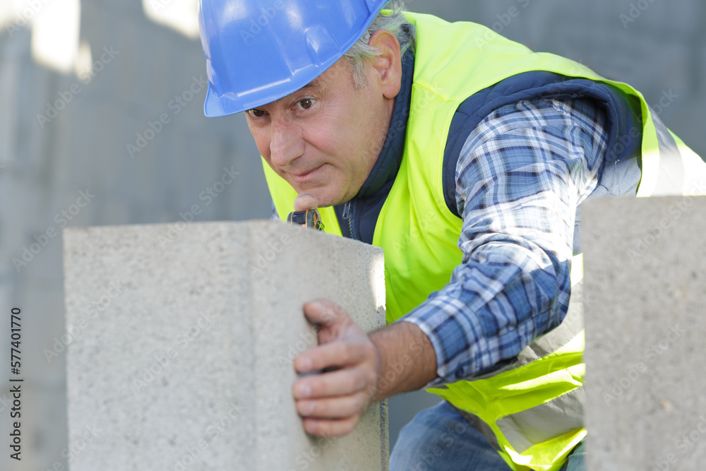 worker moving a concrete block Stock Photo | Adobe Stock