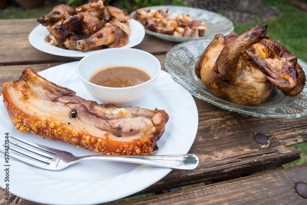 Plates of Lechon Manok or roasted chicken and Liempo or grilled pork ...