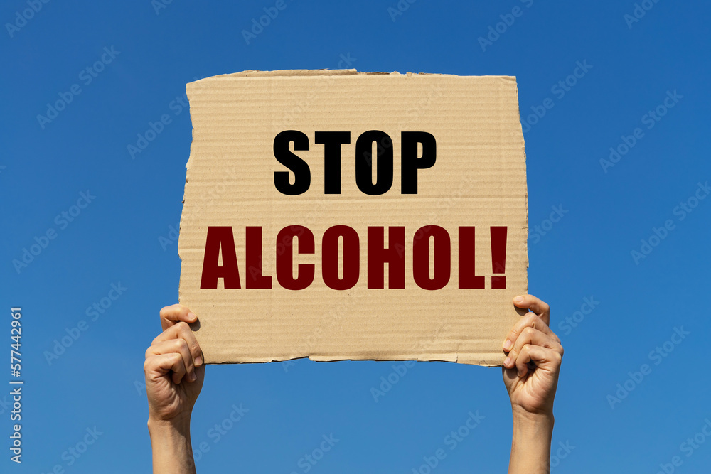 Stop alcohol text on box paper held by 2 hands with isolated blue sky ...