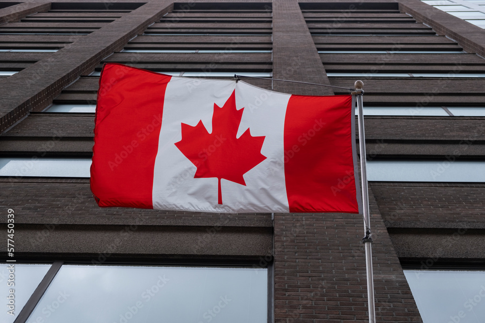 Canadian flag waving on a government building facade. Stock Photo ...