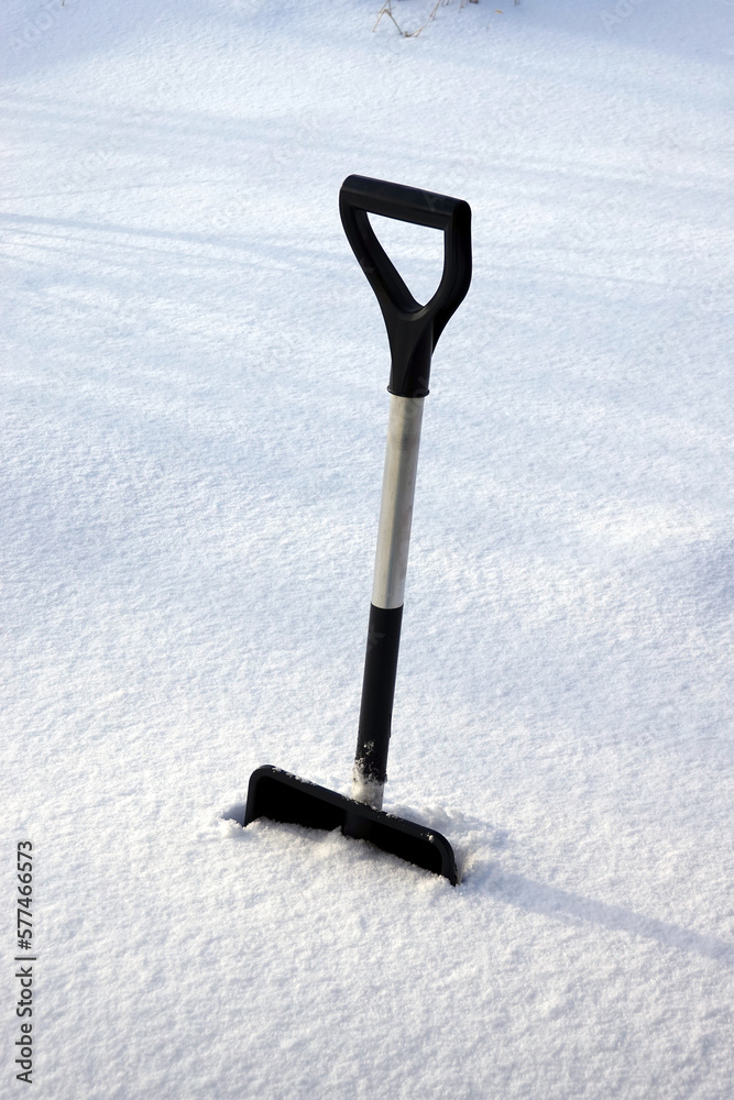 Metal shovel with black handle shovel javed deep in the snow on smooth ...