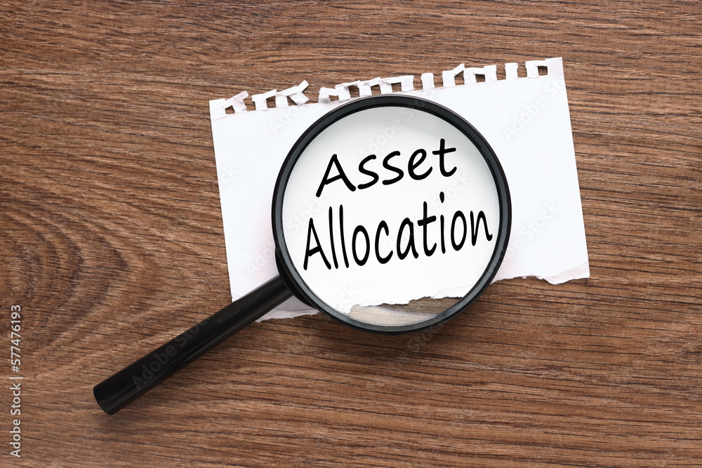 asset allocation wooden background with text on magnifier glass ...