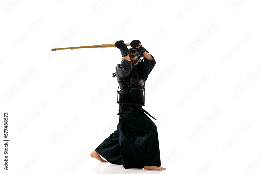 Portrait of man, professional kendo athlete in uniform posing, training ...