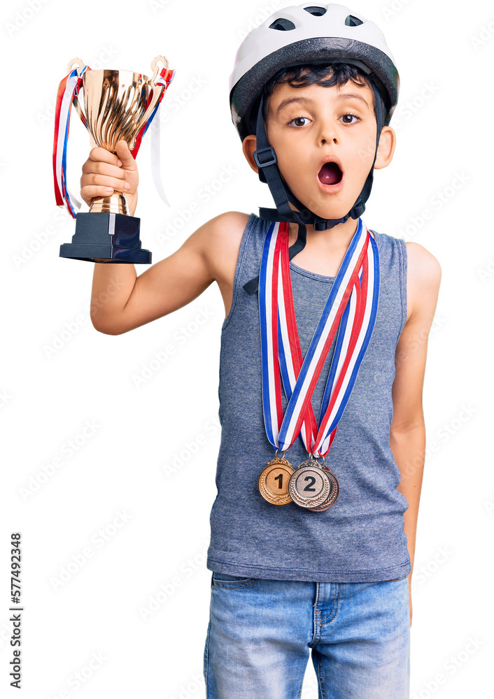 Little cute boy kid wearing bike helmet and winner medals holding ...
